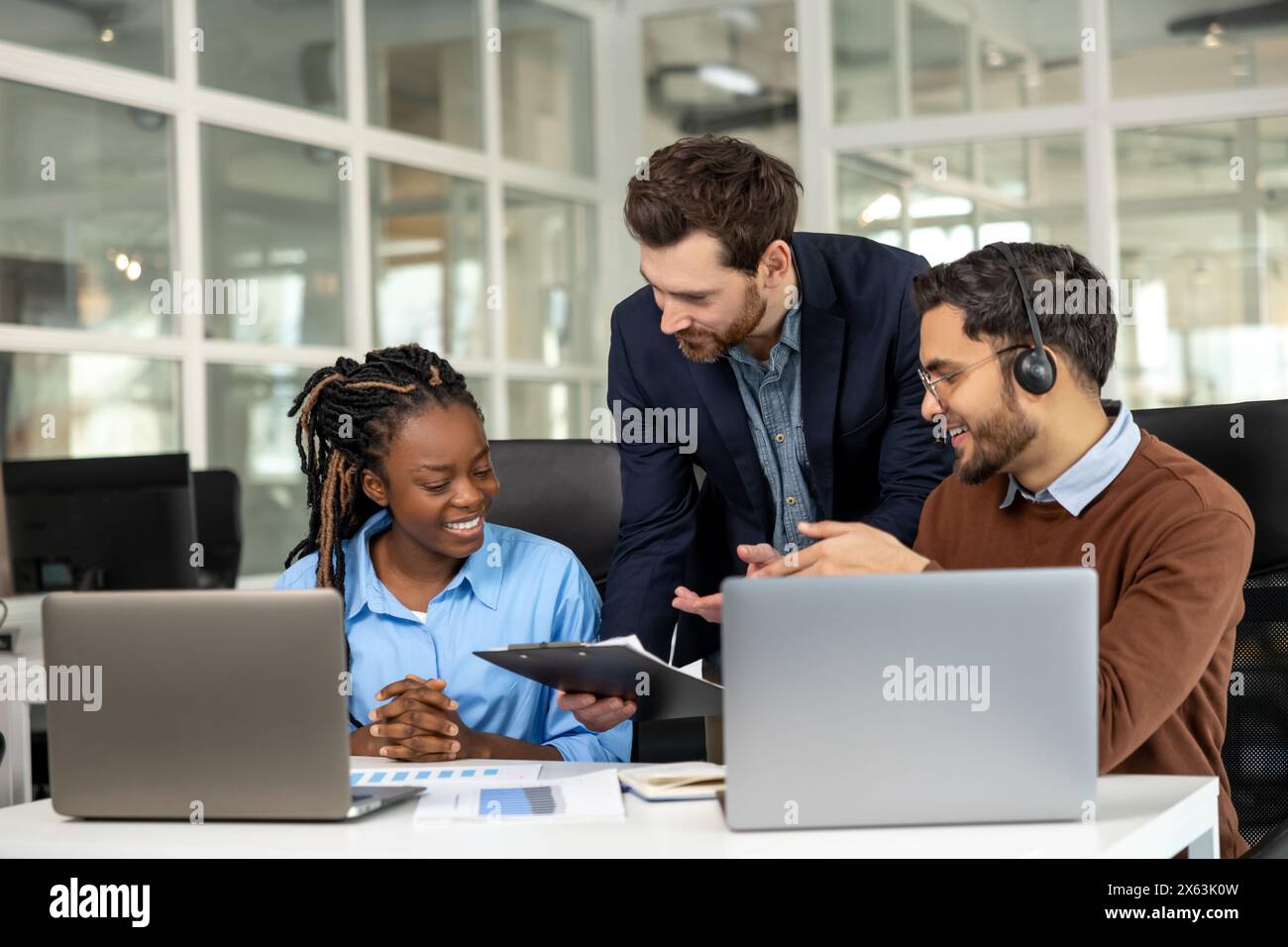 Diverse colleagues collaborating on project together Stock Photo - Alamy