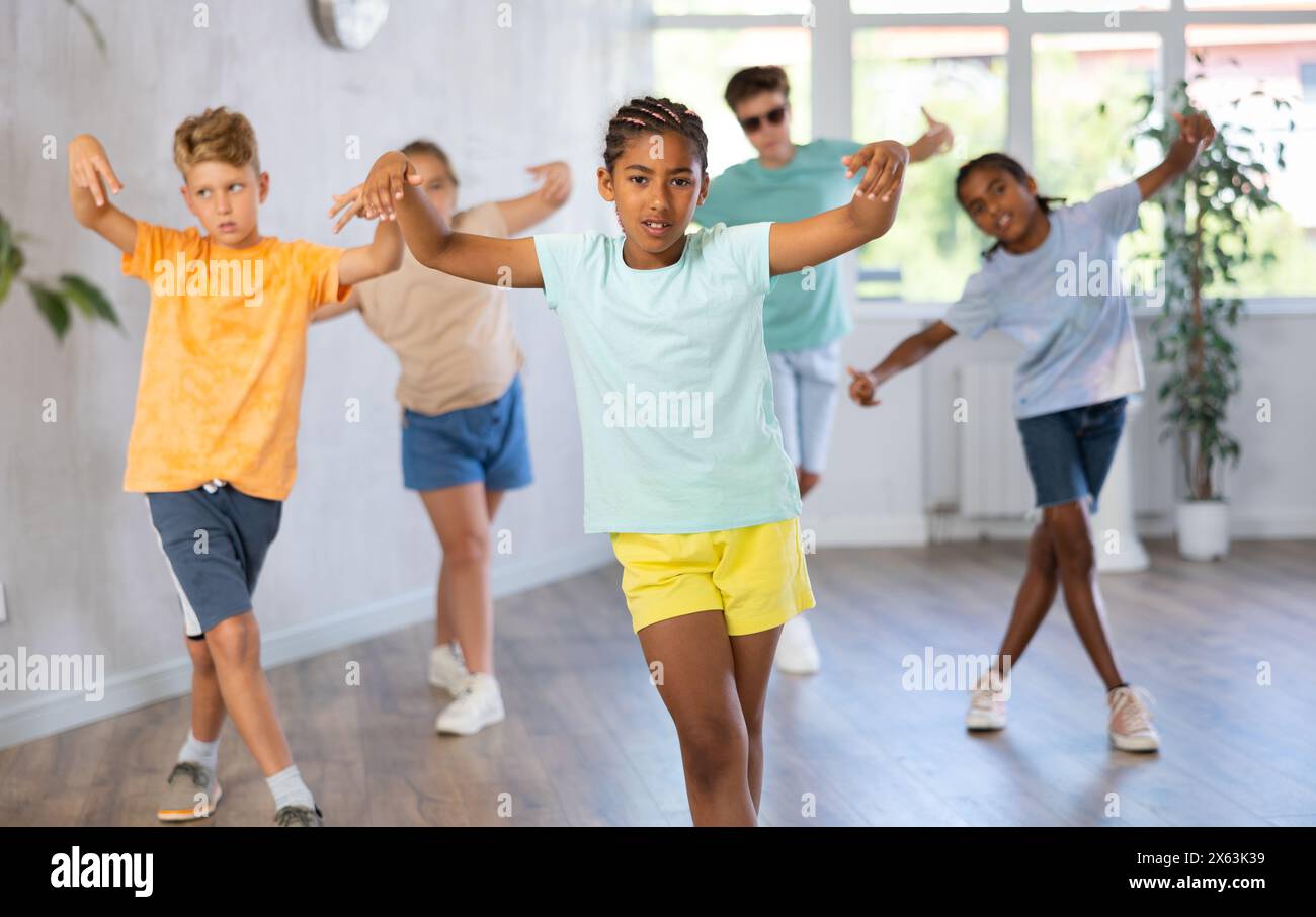 Dark-skinned tween girl krumper posing during workout in dance class ...