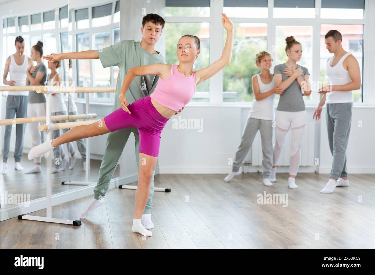 Ballet studio - teenagers girls and boys learn ballet movements in ...