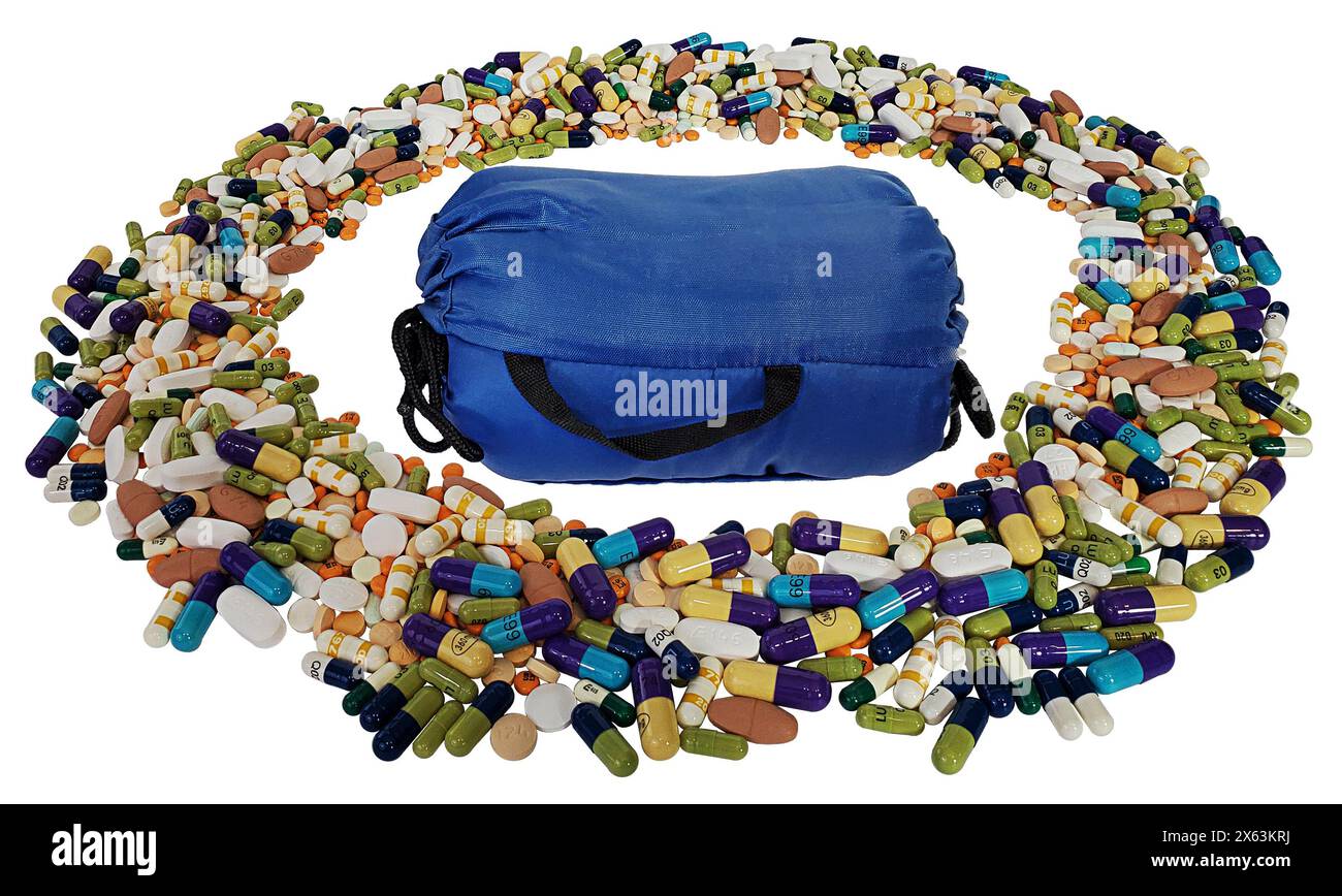 Blue rolled up sleeping bag for sleeping outdoors and pills showing ...