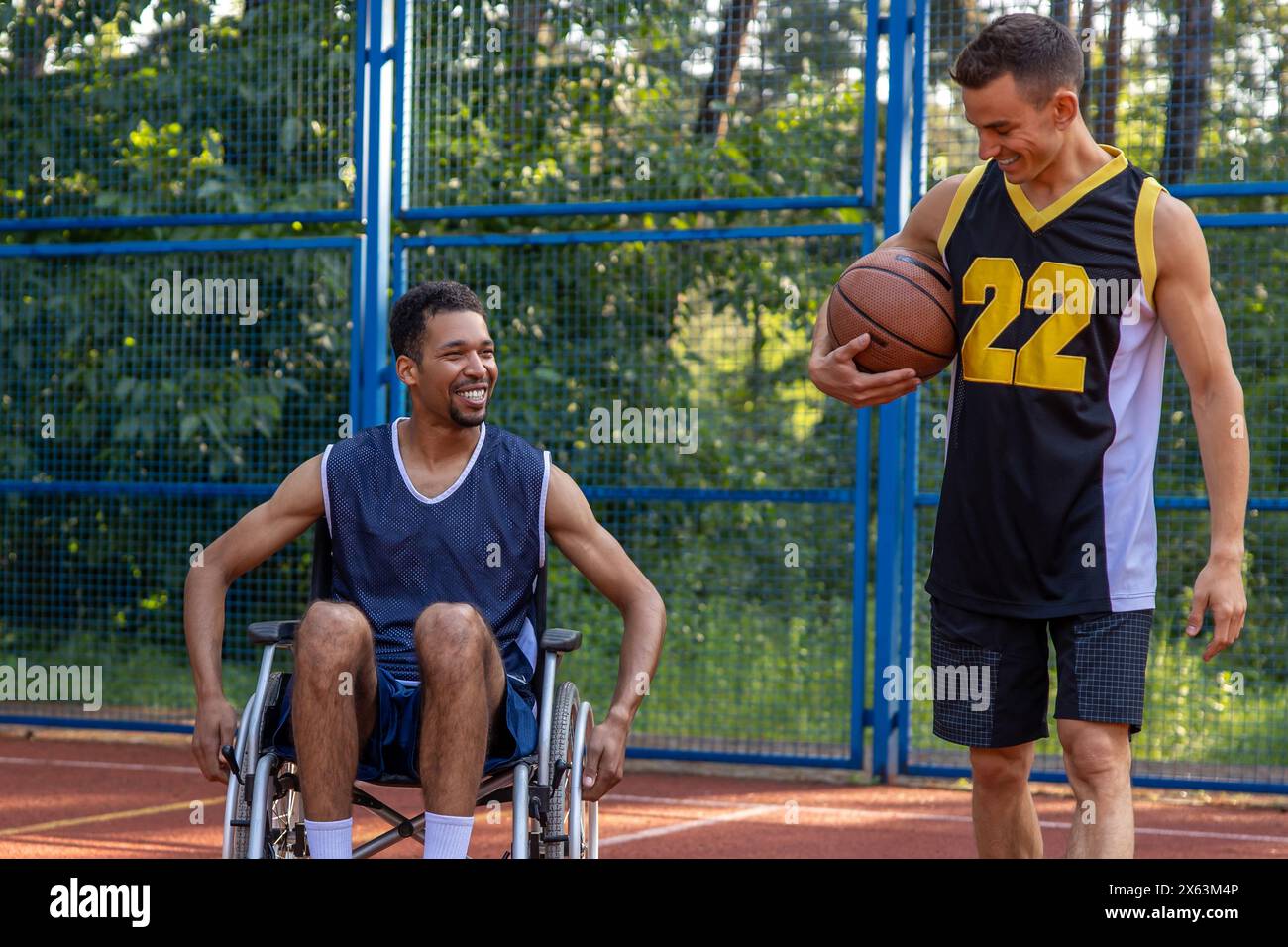 Athlete with disability training and exercising with friend on ...