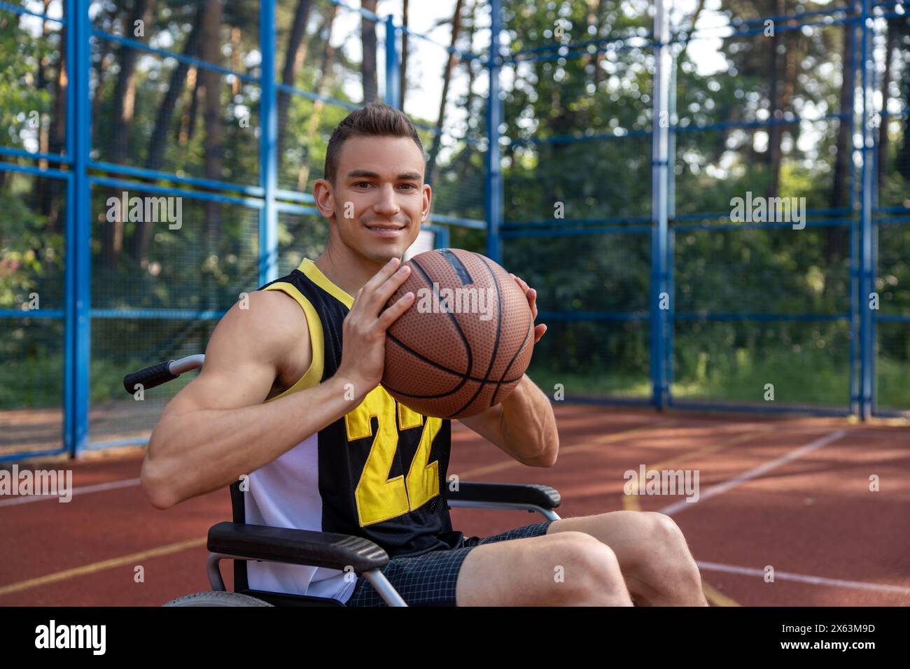 Handsome man with disability playing basketball in wheelchair Stock ...