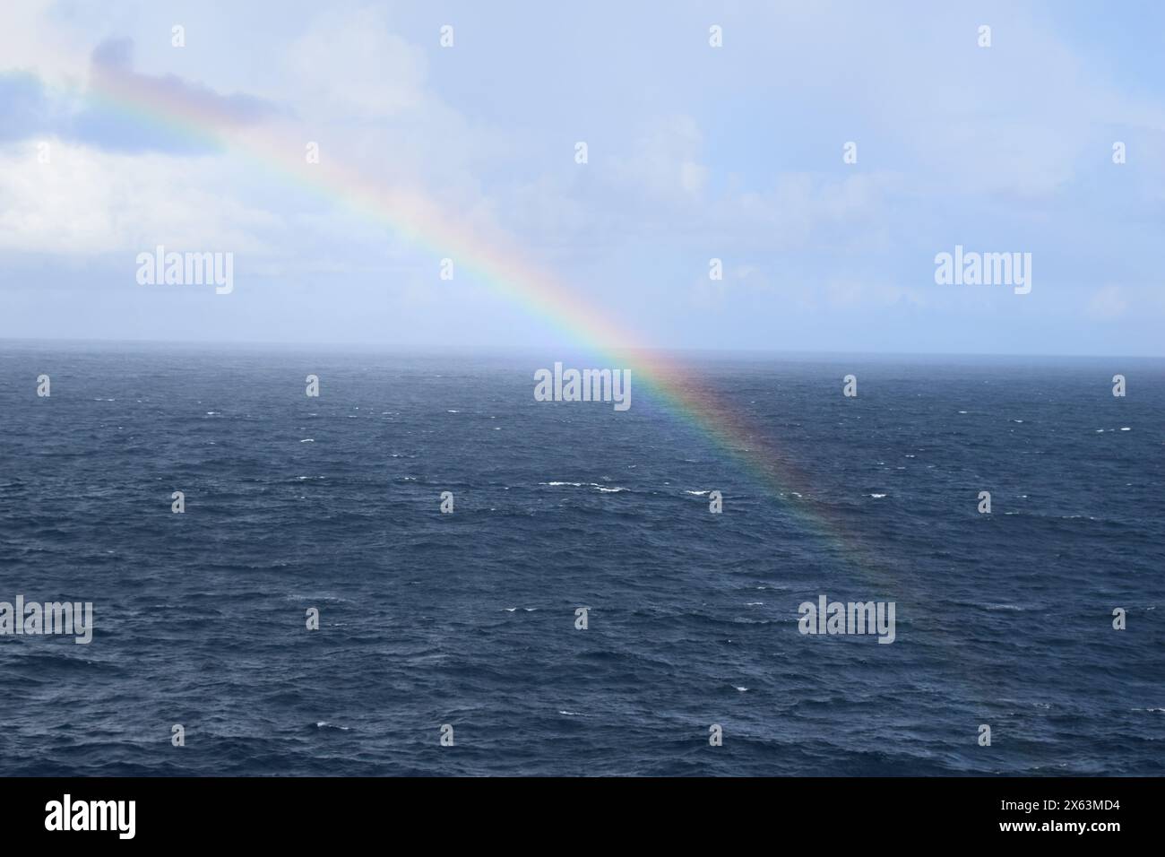 Rainbow over the ocean Stock Photo - Alamy