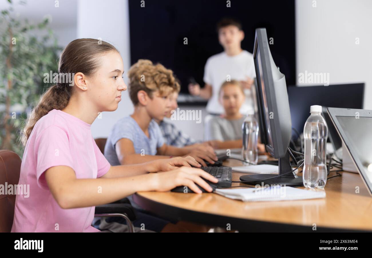 Girl student learning to work on computer in classroom Stock Photo - Alamy