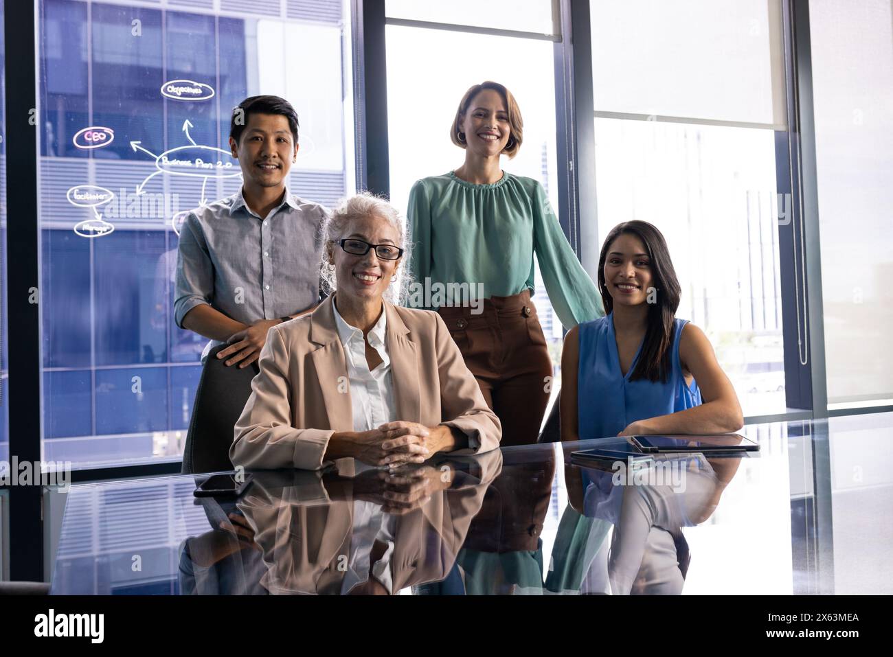 At office, diverse team gathering around a glass table Stock Photo - Alamy