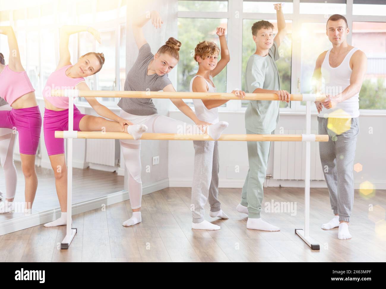 Ballet pose grand batman - girls and boys at a choreography lesson are ...