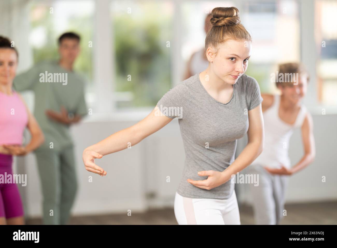 Teenage girl practicing ballet positions in dance studio Stock Photo ...