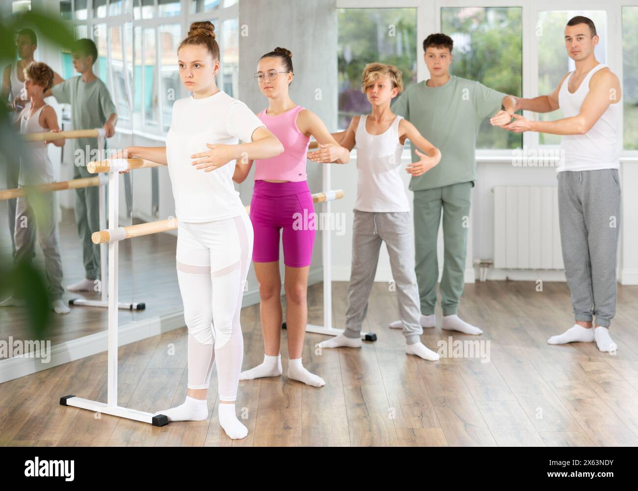Girls and boys in ballet class perform second position Stock Photo - Alamy