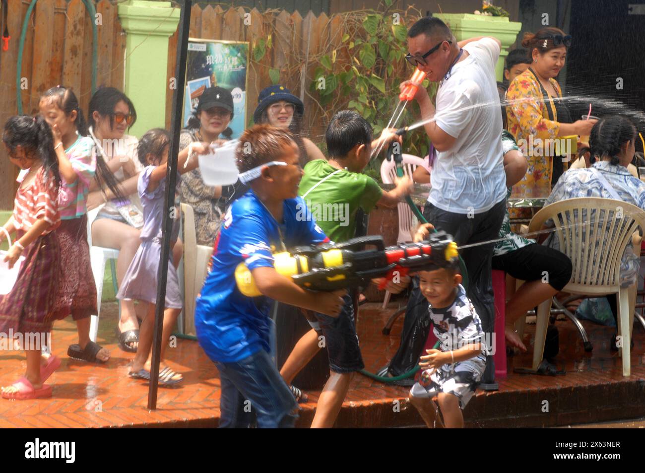 Boy with water pistol at the Pi Mai parade as part of New Year ...