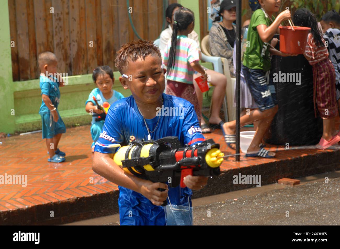 Boy with water pistol at the Pi Mai parade as part of New Year ...