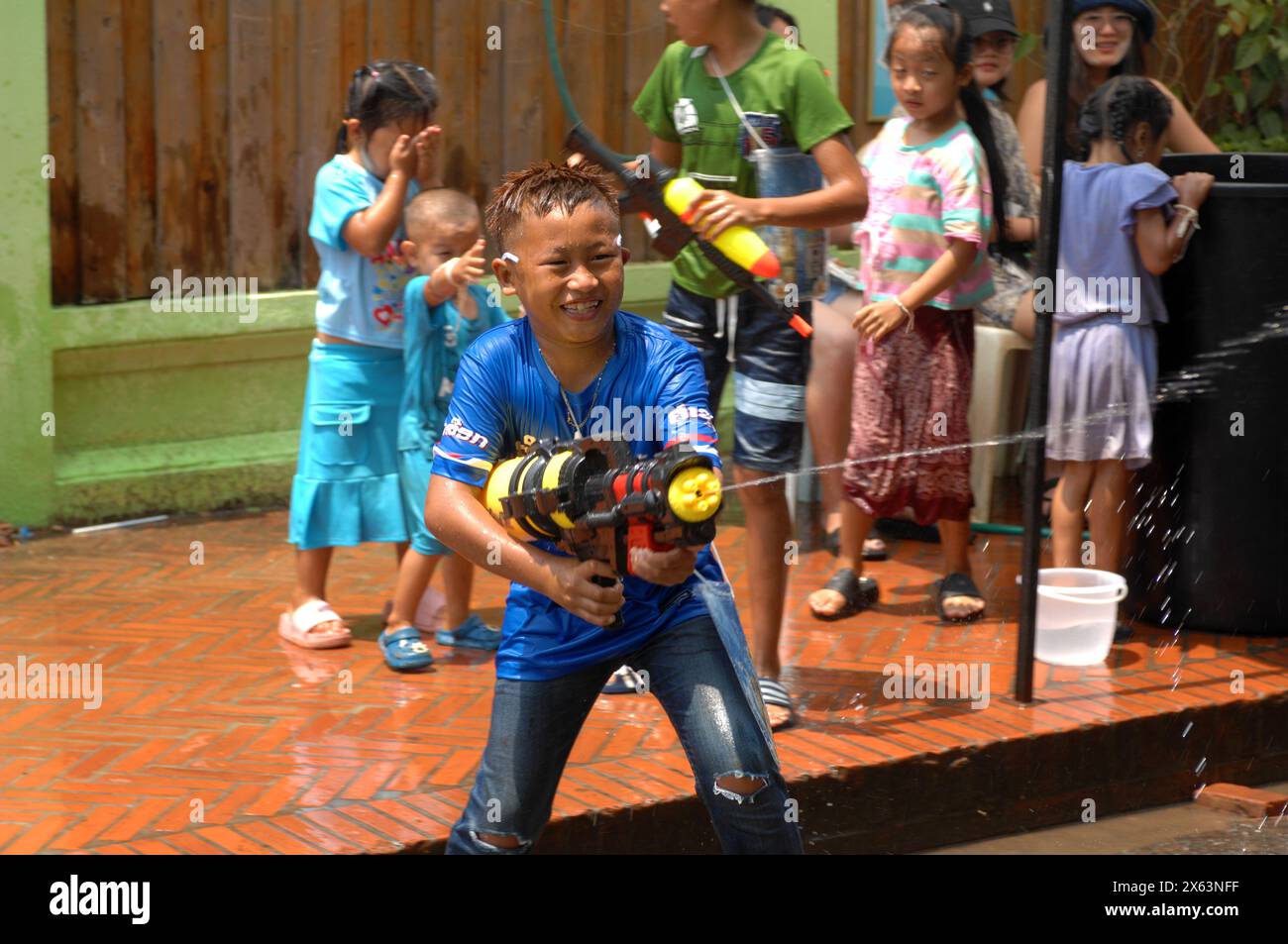 Boy with water pistol at the Pi Mai parade as part of New Year ...