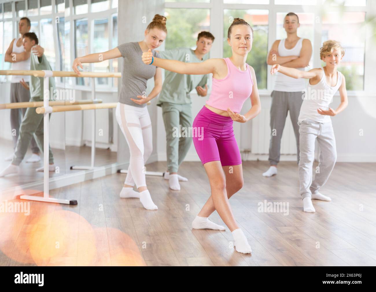 Teenage girl practicing ballet positions in dance studio Stock Photo ...