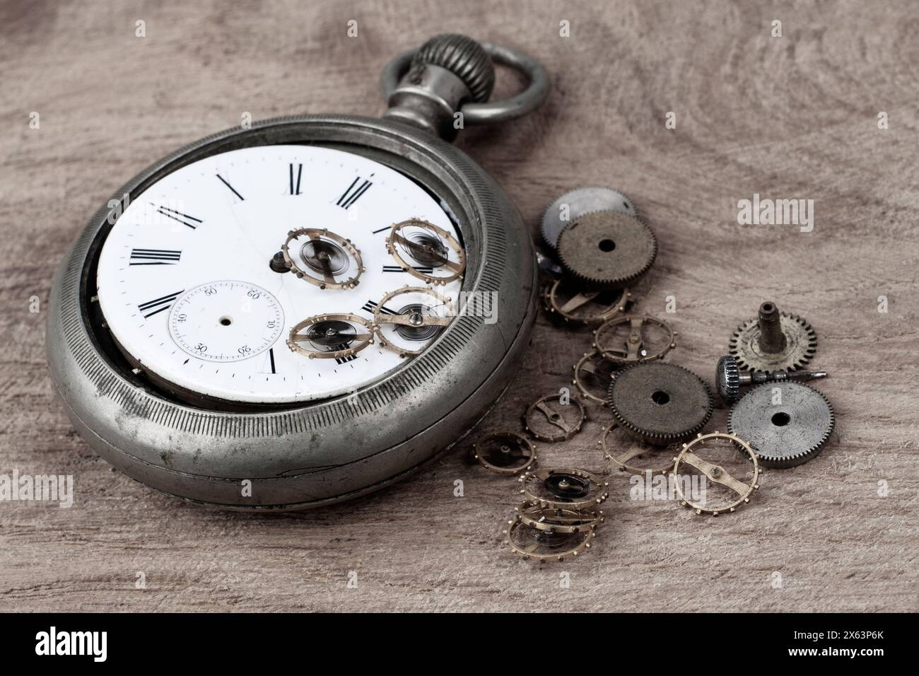 broken vintage pocket watch on wooden background Stock Photo - Alamy