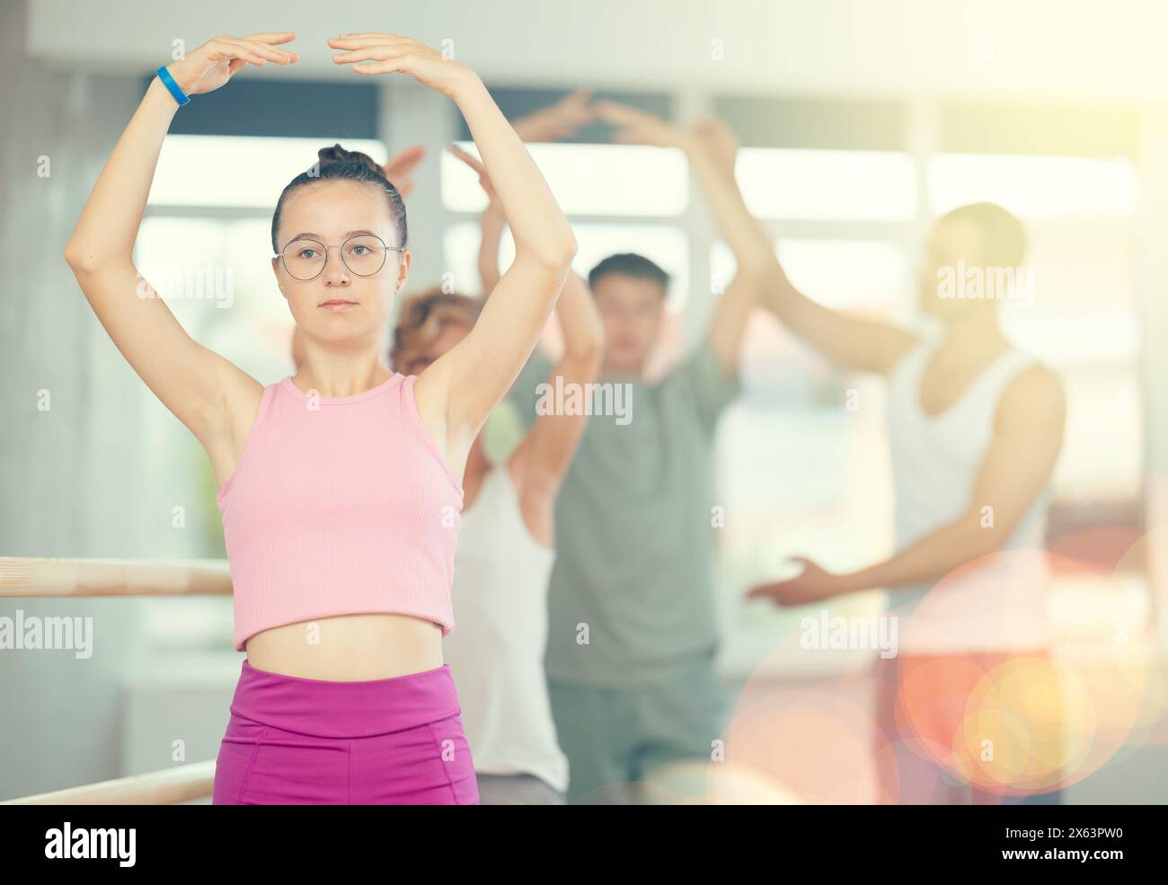 Teenage girl practicing ballet positions in dance studio Stock Photo ...