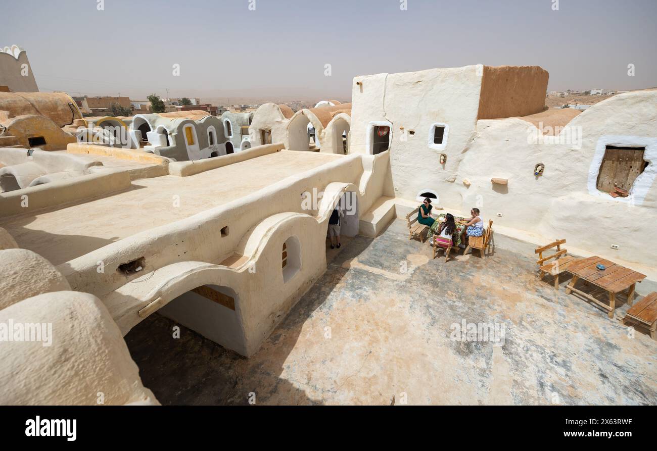 Tourists relaxing at Ksar Hadada hotel with traditional Berber architecture Stock Photo - Alamy