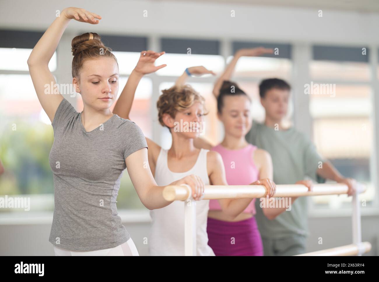 Teenage girl practicing ballet positions in dance studio Stock Photo ...
