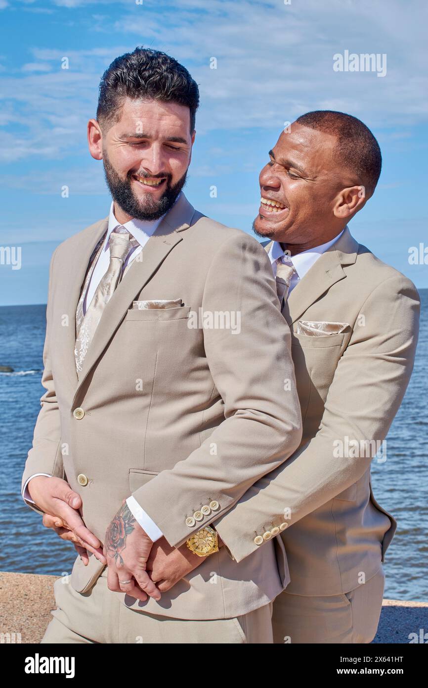 Two guys celebrating diversity, their love made public on the beach ...