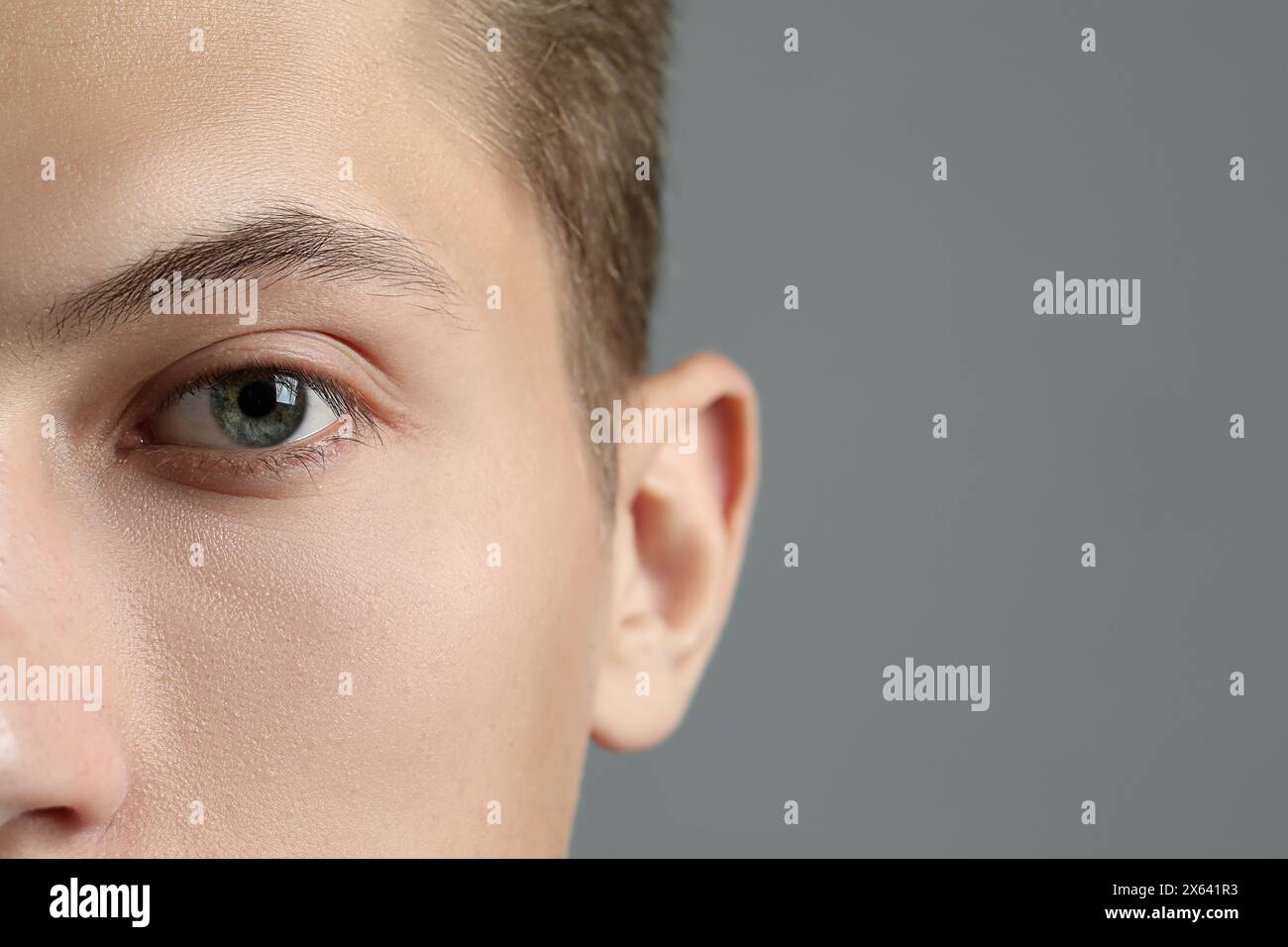 Perfect vision. Man with beautiful eyes on grey background, closeup ...