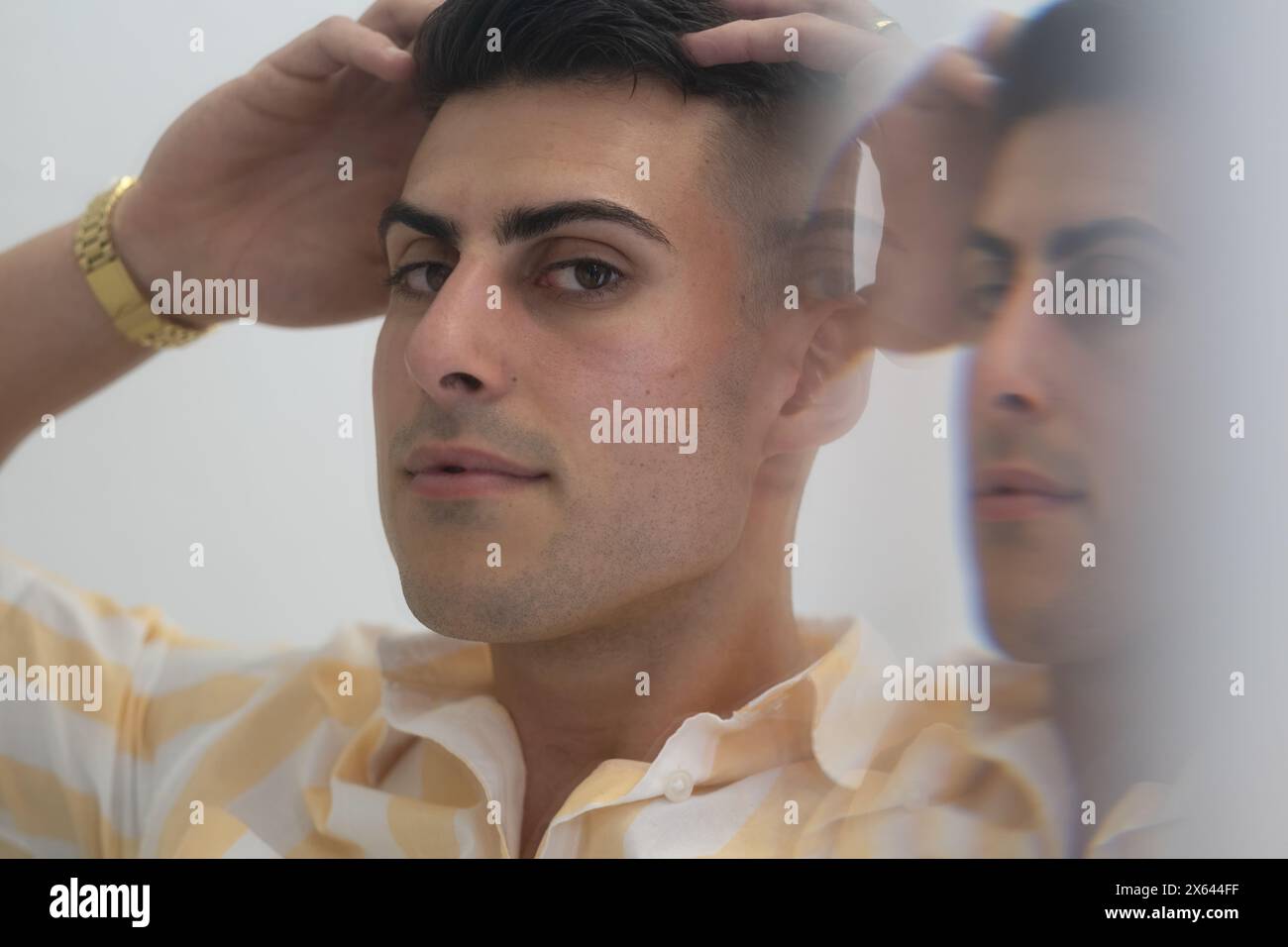 Male model arms behind head hi-res stock photography and images - Alamy