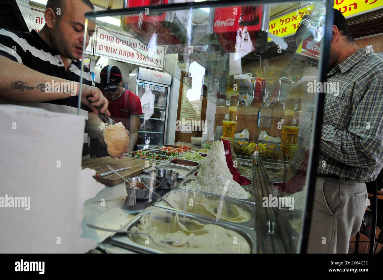 Preparing Falafel in PIta bread at the popular Super Falafel on Allenby ...