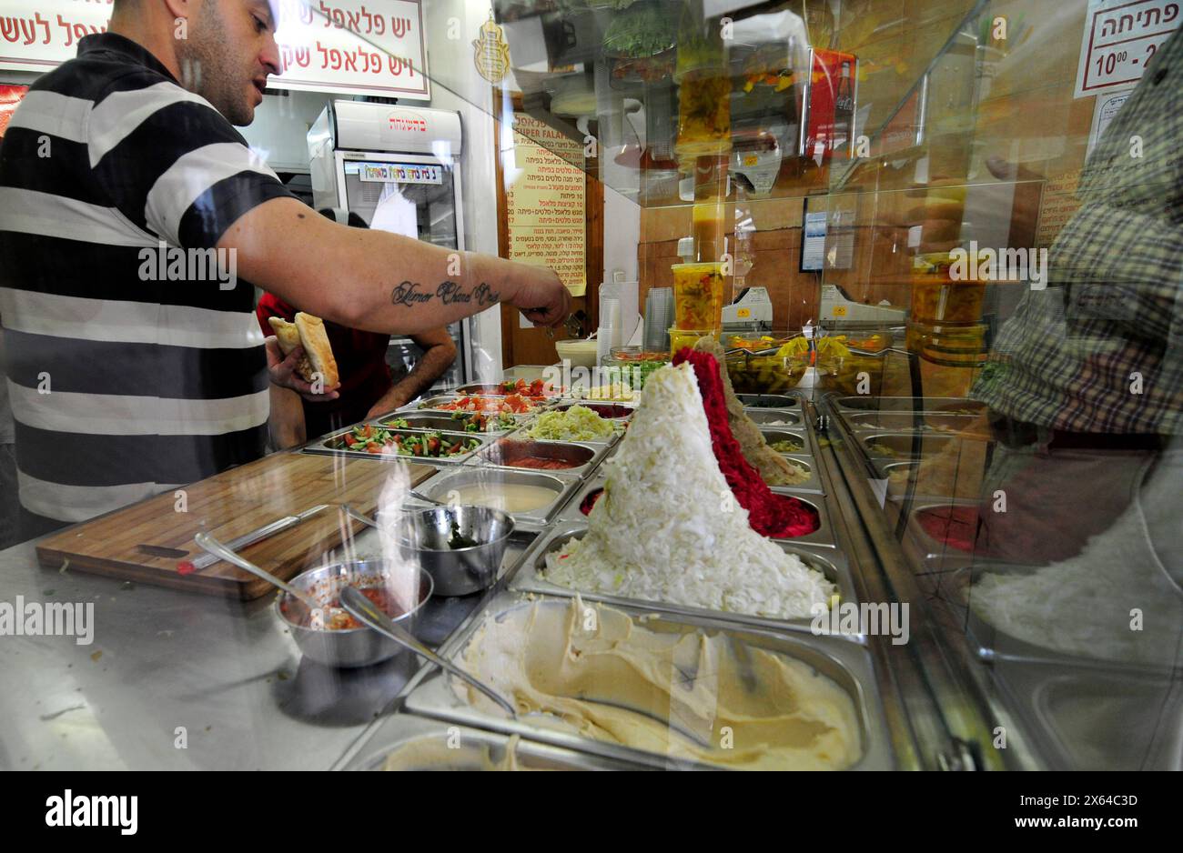 Preparing Falafel in PIta bread at the popular Super Falafel on Allenby ...