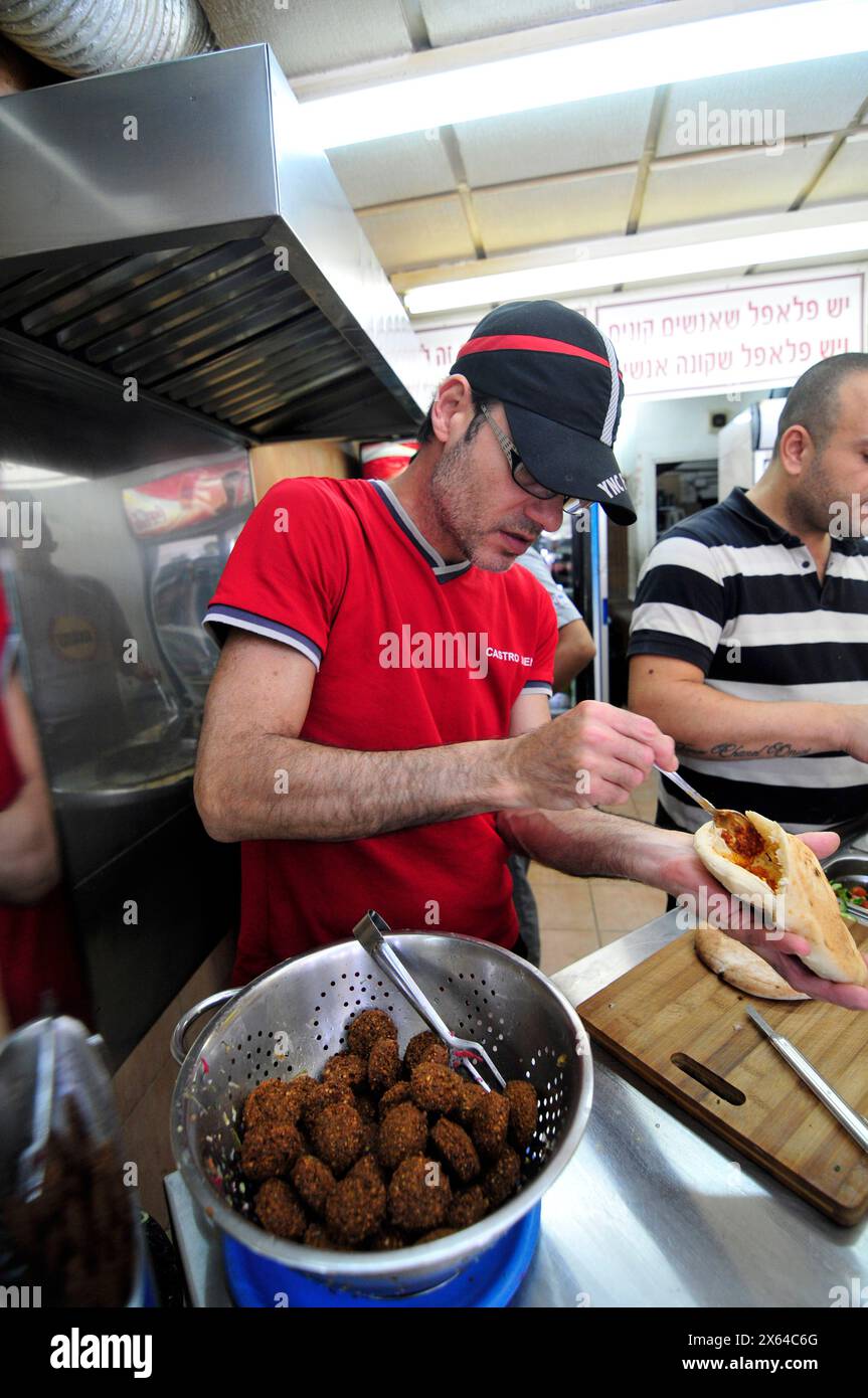 Preparing Falafel in PIta bread at the popular Super Falafel on Allenby ...