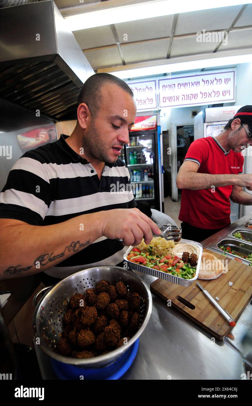 Preparing Falafel in PIta bread at the popular Super Falafel on Allenby ...