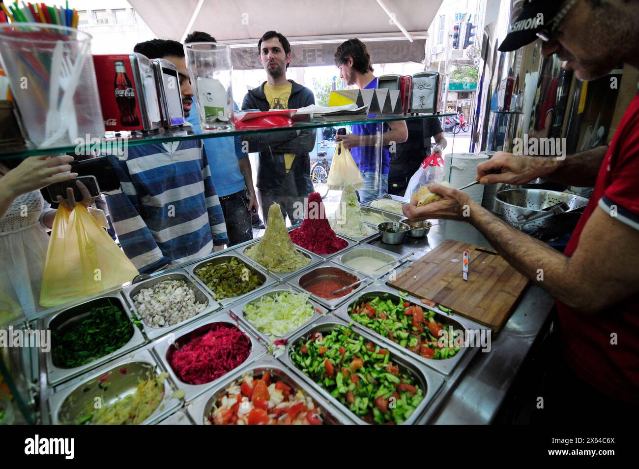 Preparing Falafel in PIta bread at the popular Super Falafel on Allenby ...