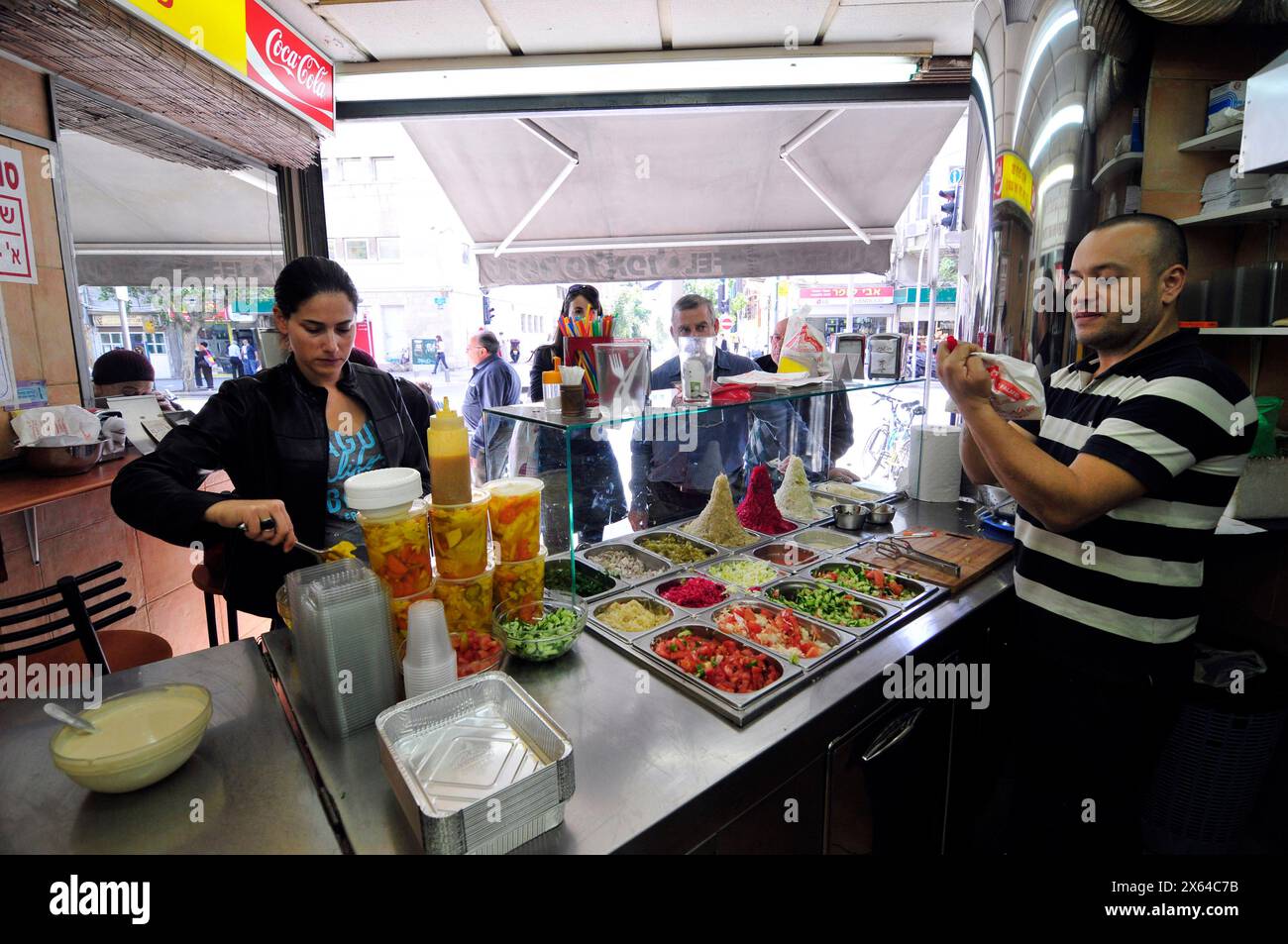 Preparing Falafel in PIta bread at the popular Super Falafel on Allenby ...