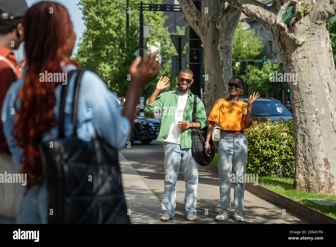 Meeting friends for walks. Two happy couples of students see each other ...