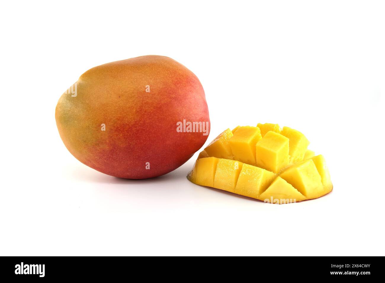 Ripe mango with red and yellow skin near cut half mango with the flesh ...