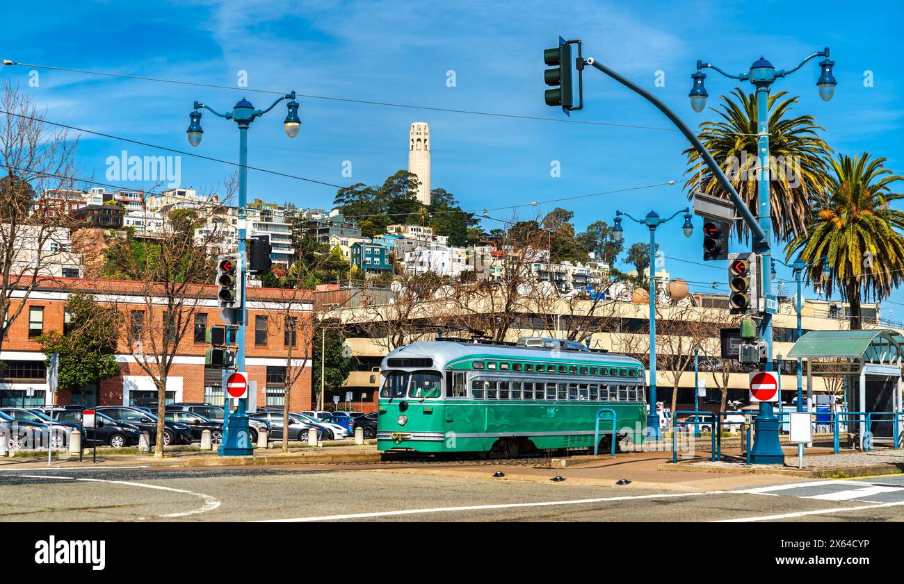 Historic streetcar on the Embarcadero with the iconic Coit Tower in the ...