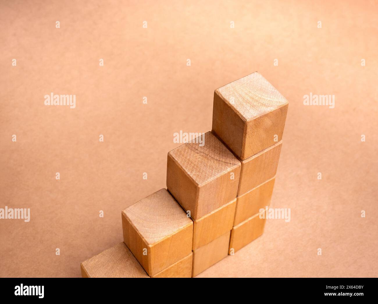 Blank wooden cube blocks bar graph chart four steps, isolated on brown ...
