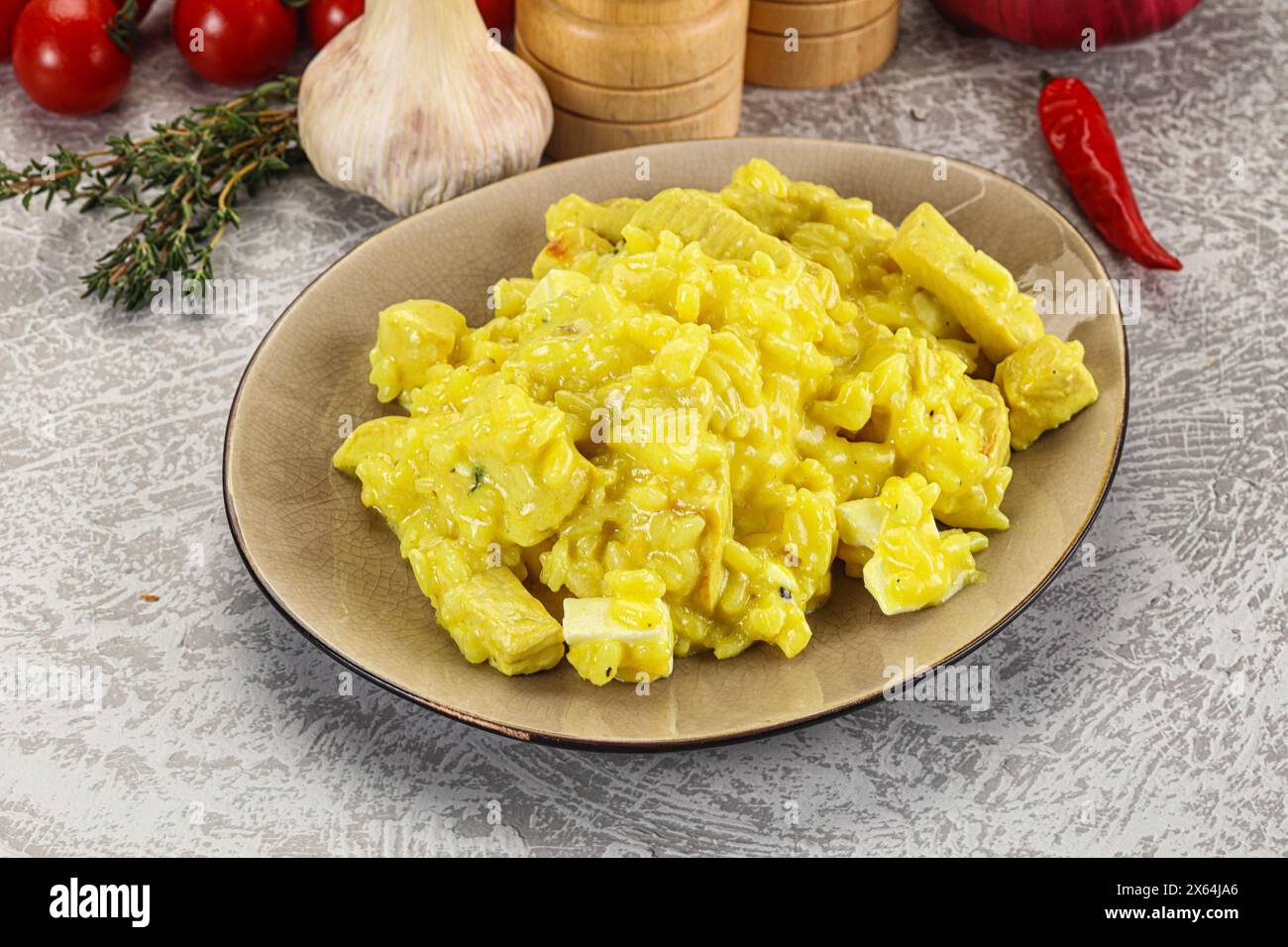 Italian cuisine - yellow risotto with chicken and soft cheese Stock ...