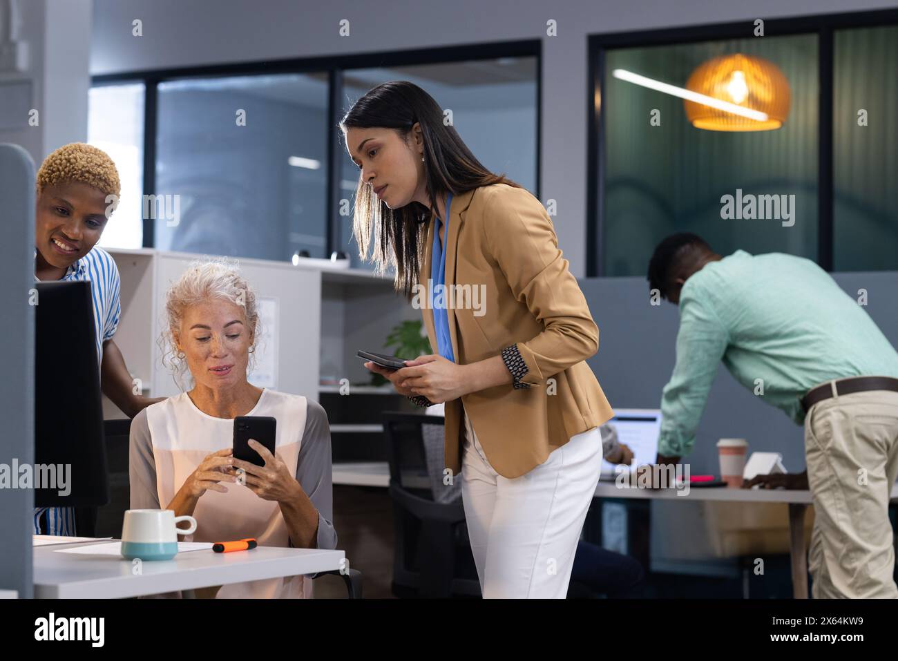 Diverse team collaborating at office, sharing ideas Stock Photo - Alamy