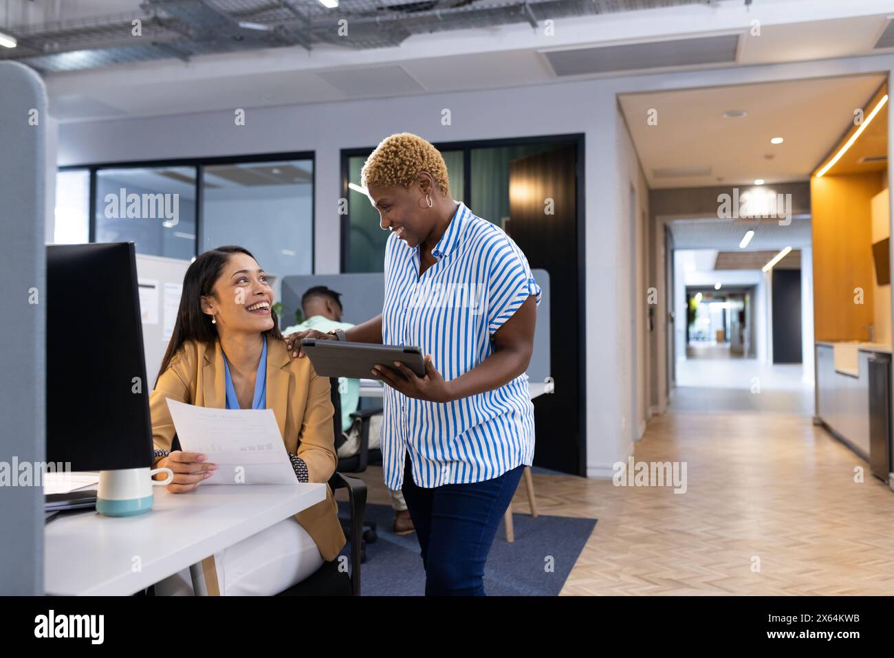 Diverse team discussing business documents at office, sharing happy ...