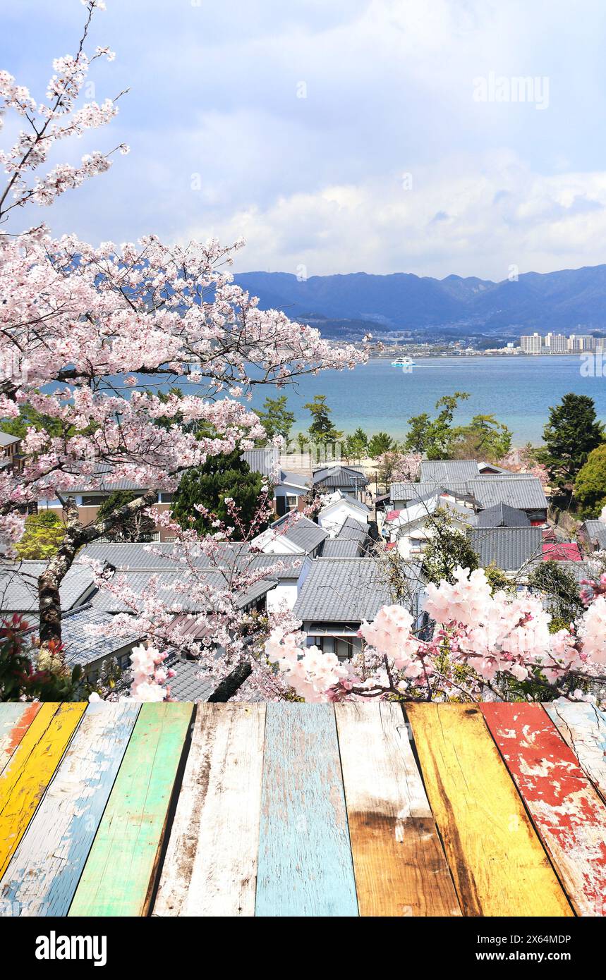 Blank wooden table top and aerial view on sea, houses and blooming ...