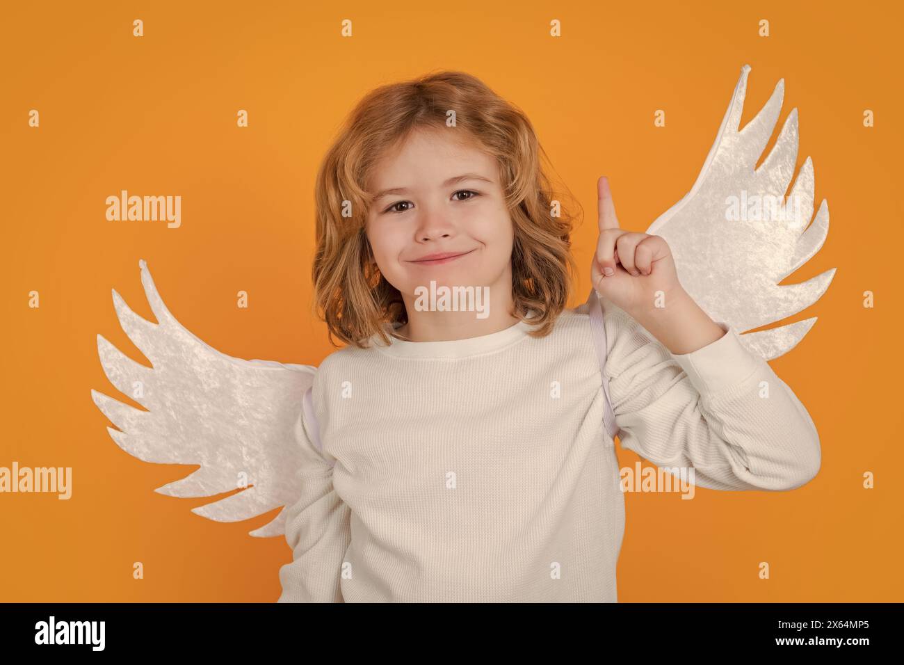 Child angel pointing up, point gesture, idea. Little cute child at ...