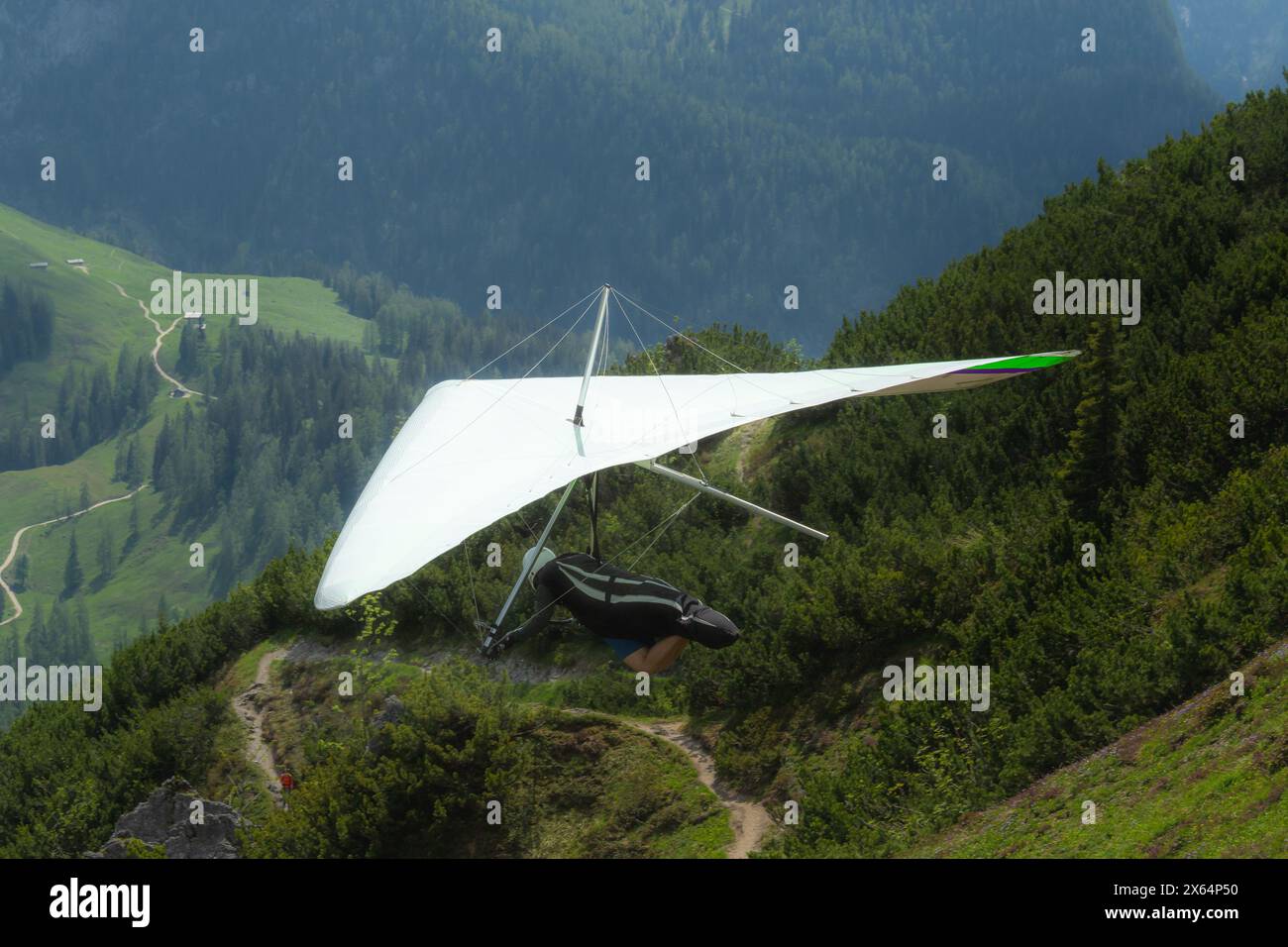 Hang gliding above mountain valley near Jenner mount and Konigssee lake ...