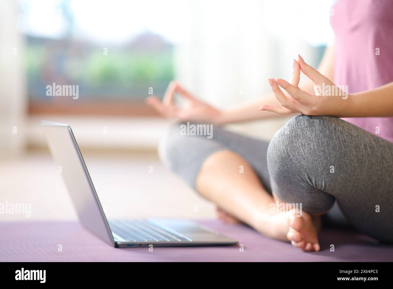 Close up side view portrait of a woman watching yoga tutorial on laptop ...