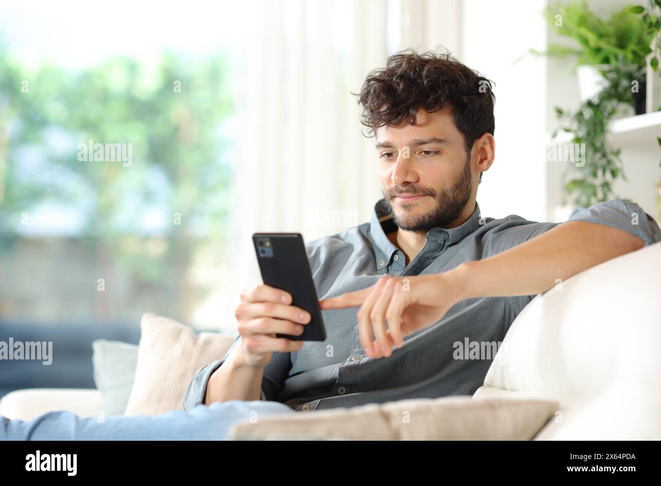 Using smartphone watching tv hi-res stock photography and images - Alamy