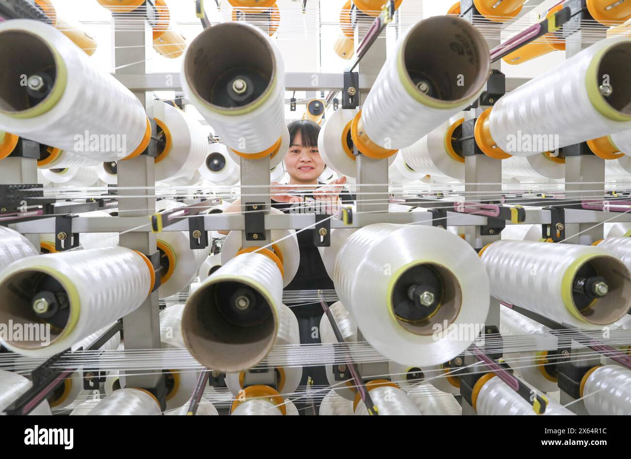 HUZHOU, CHINA - MAY 13, 2024 - A worker is producing bulletproof ...