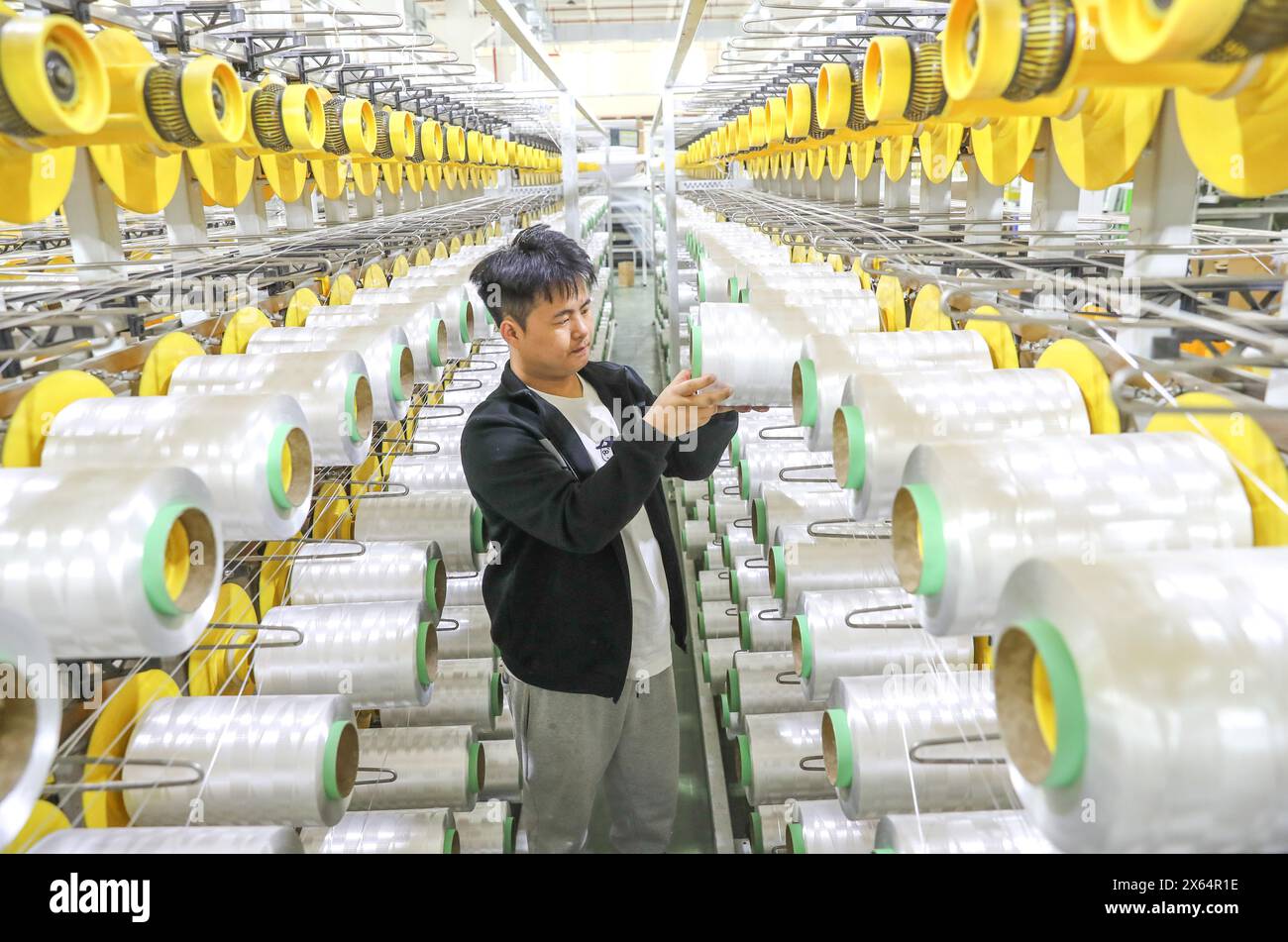 HUZHOU, CHINA - MAY 13, 2024 - A worker is producing bulletproof ...