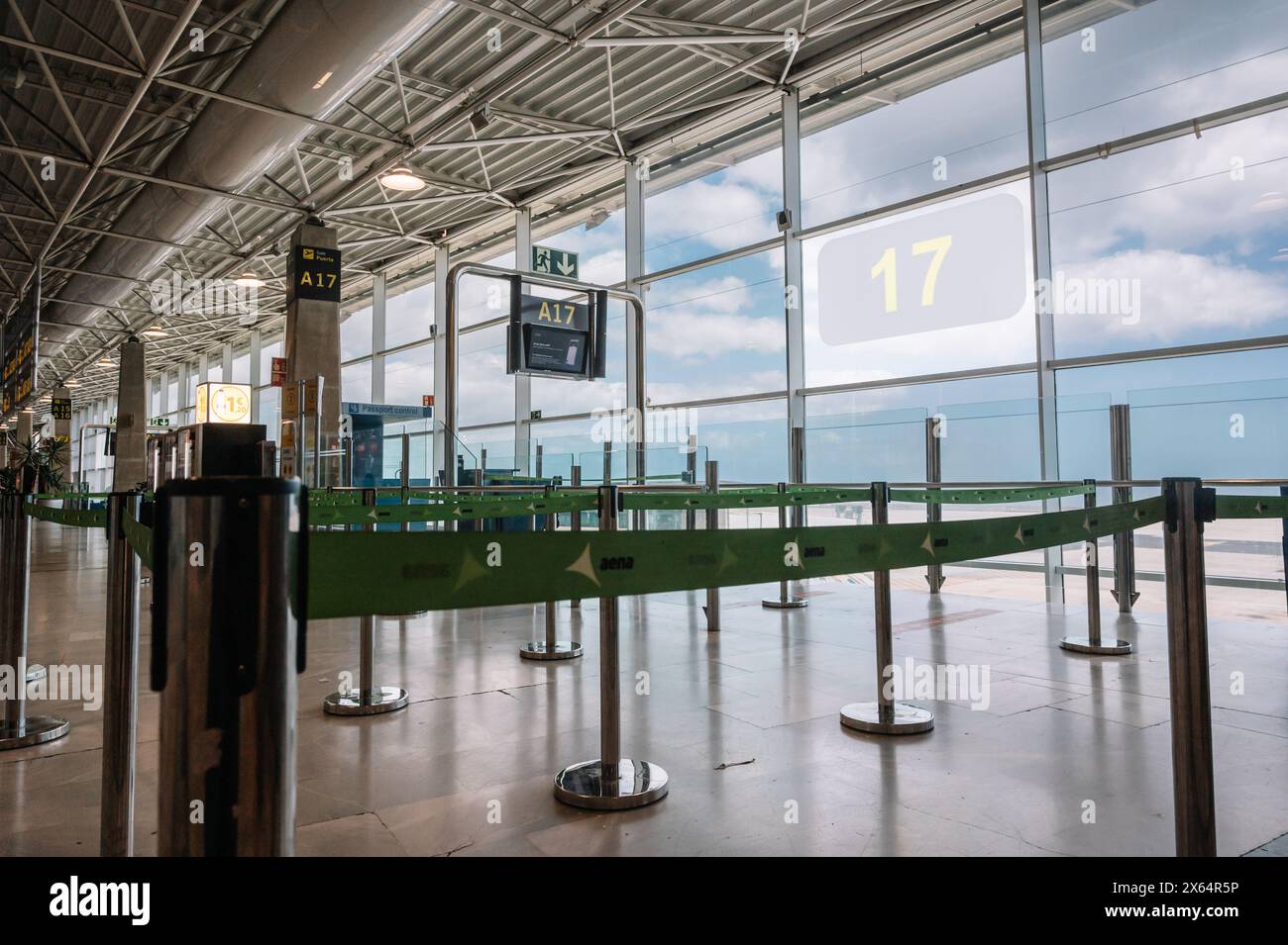 A large airport terminal with a green line marking the 17th gate. The ...