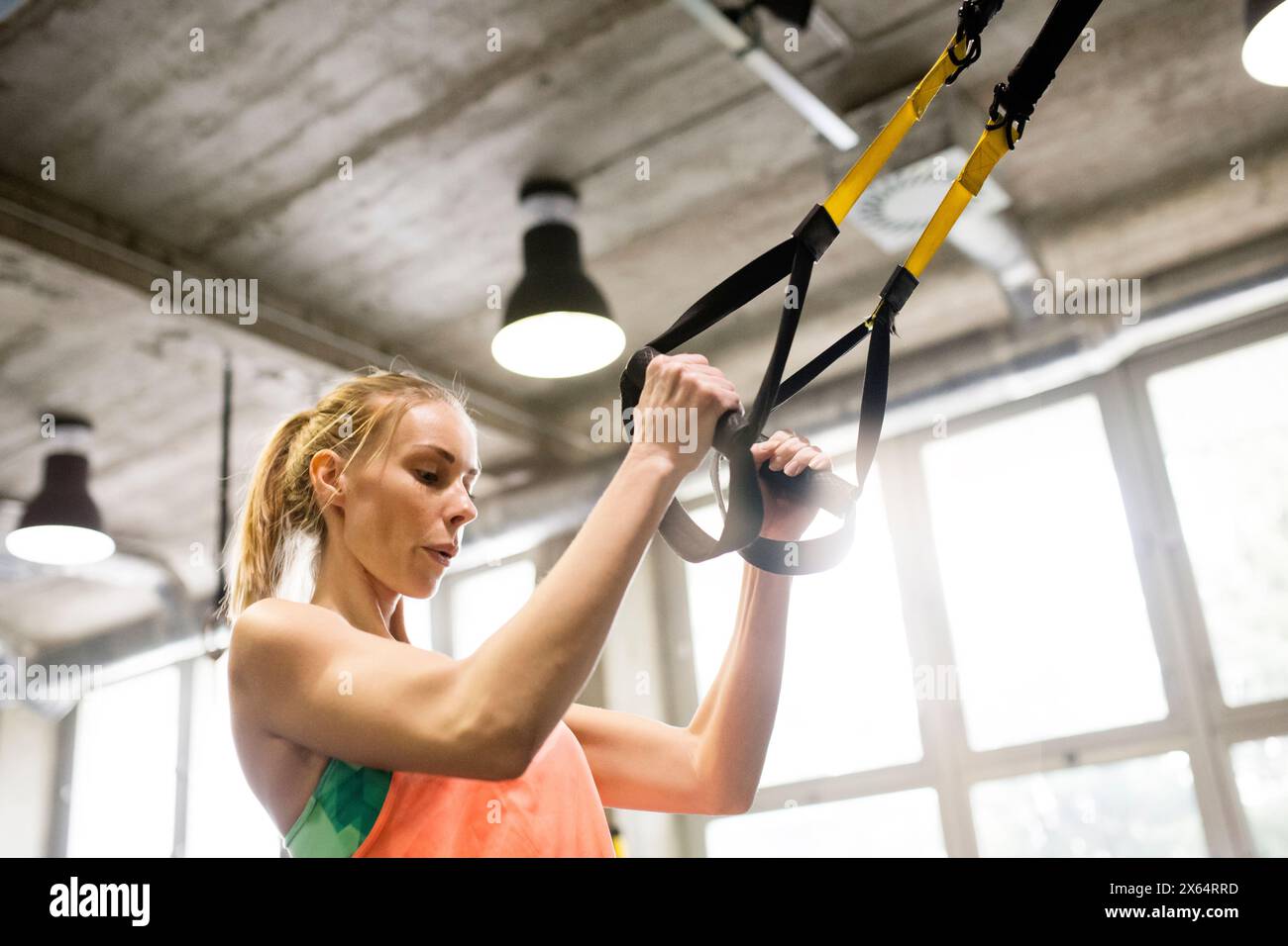 Beautiful sport woman doing suspension training, total resistance ...