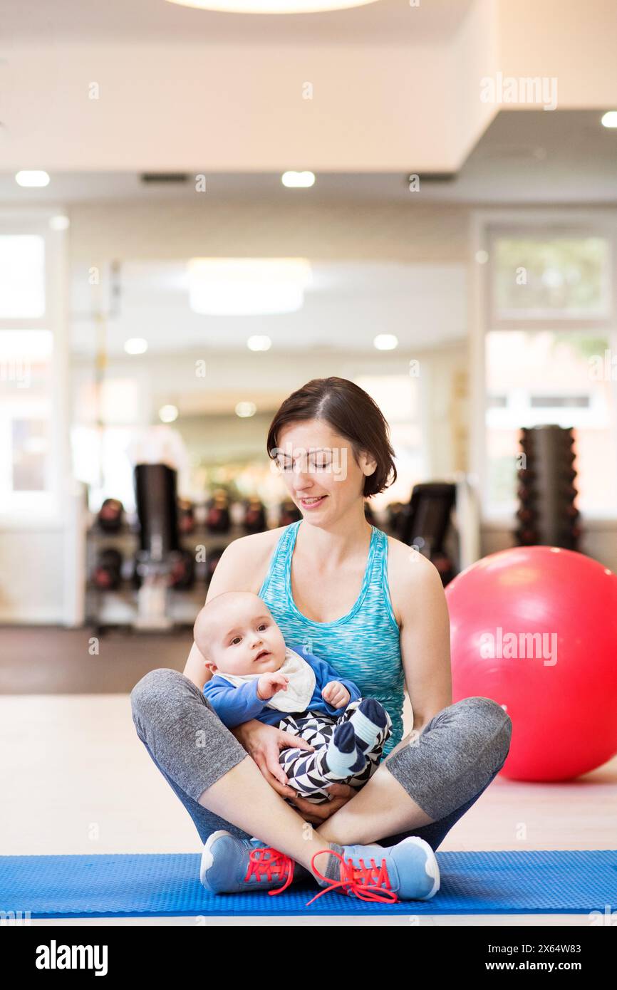 Portrait of new mom on group exercise class in gym. Moms staying active ...