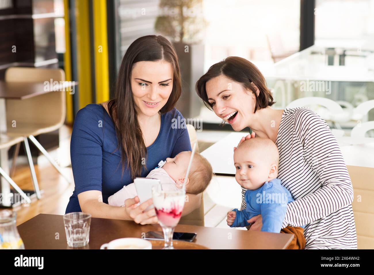 New mom friends going to cafe with babies. Spending free time during ...