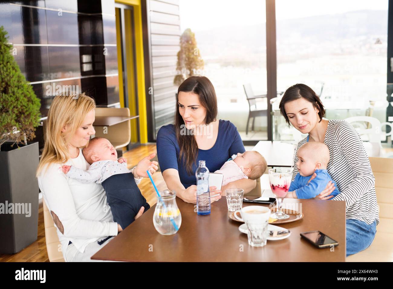 New mom friends going to cafe with babies. Spending free time during ...