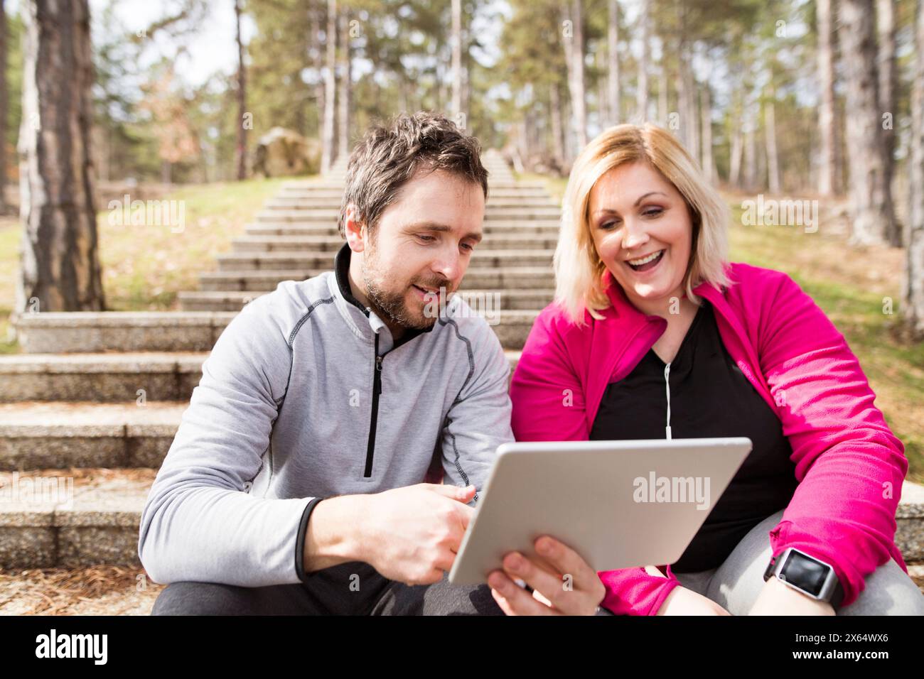 Overweight woman resting after run, personal trainer checking her ...