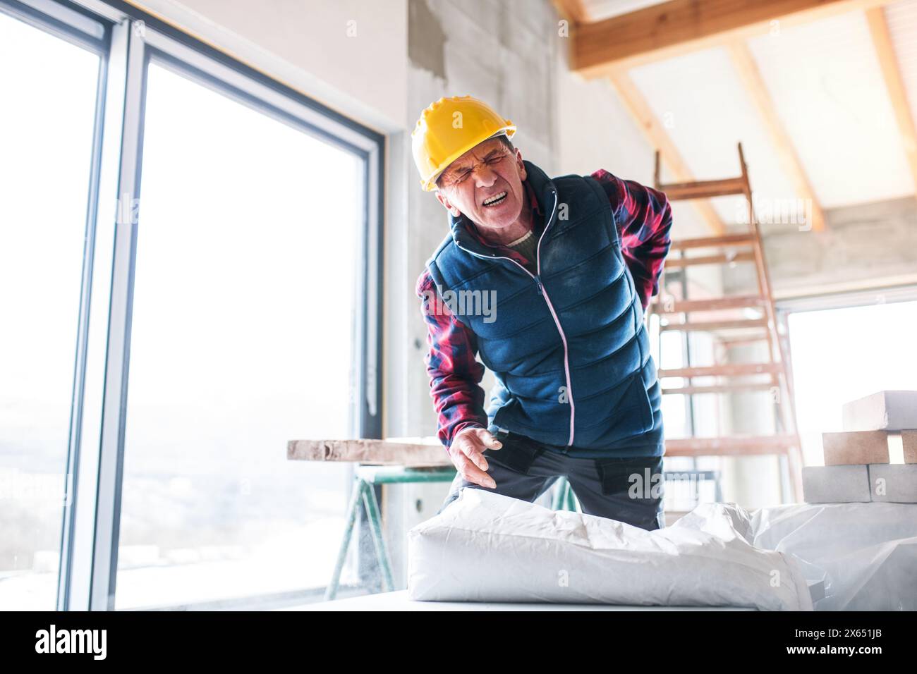 Older worker feeling pain in back after carrying heavy bag. Work ...
